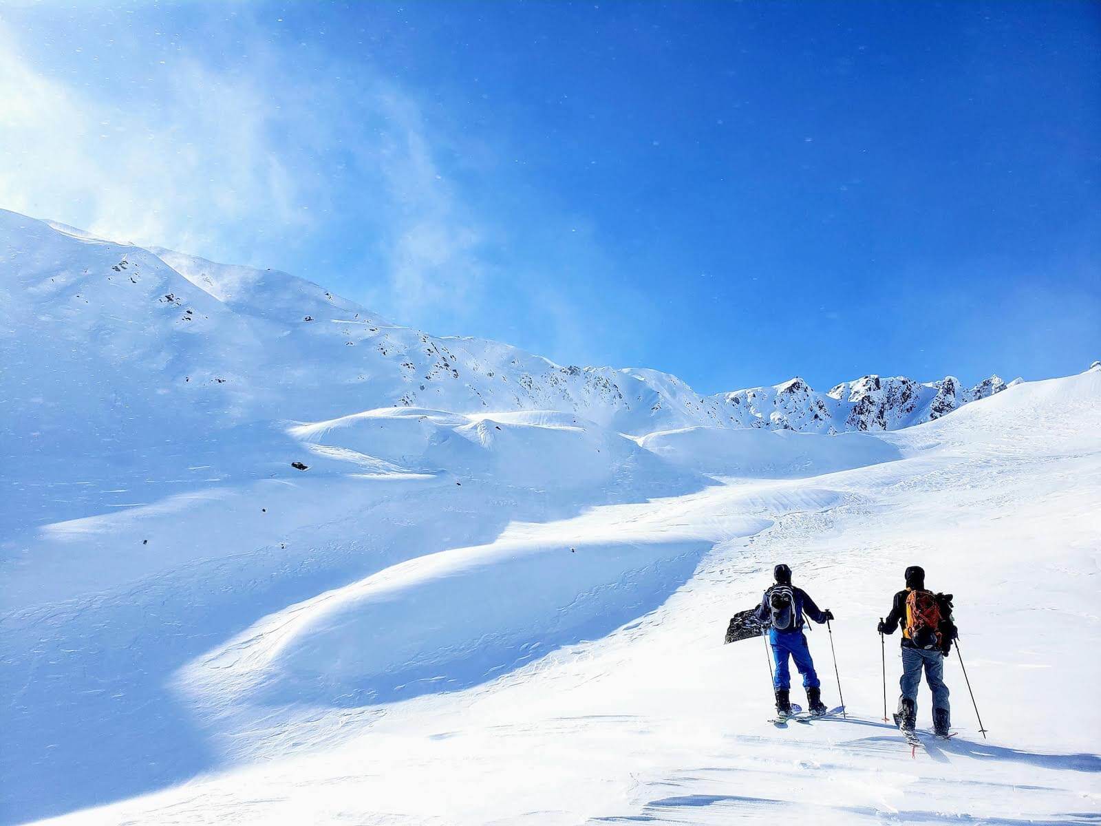 Backcountry Skiing Splitboarding by Snowmobile